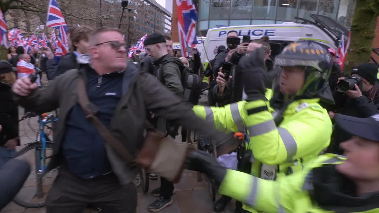Police officer punched in face in Manchester as counter-protesters ...