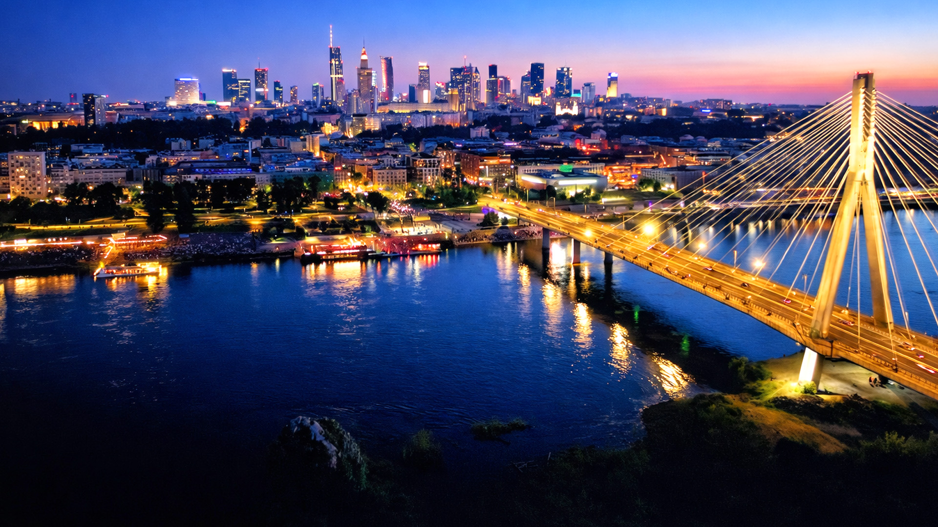 Warsaw capital city skyline lights over the Vistula River