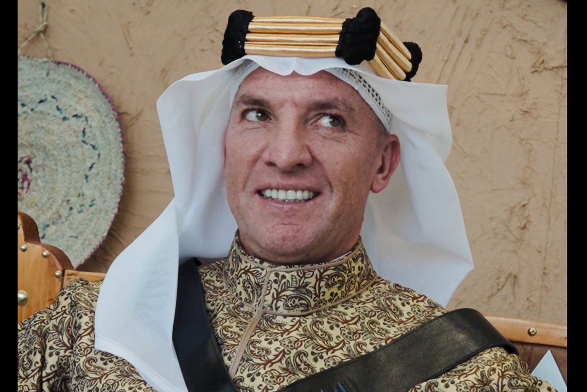 Rodgers holds gun wearing traditional Saudi dress in promotional video