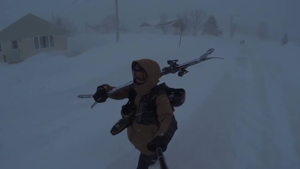 Snowboarder walks through deep snow