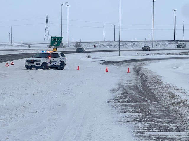 Truck dangles from snowy highway overpass in Winnipeg after crash