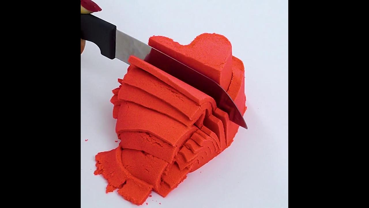 Knife cutting red heart sand ASMR