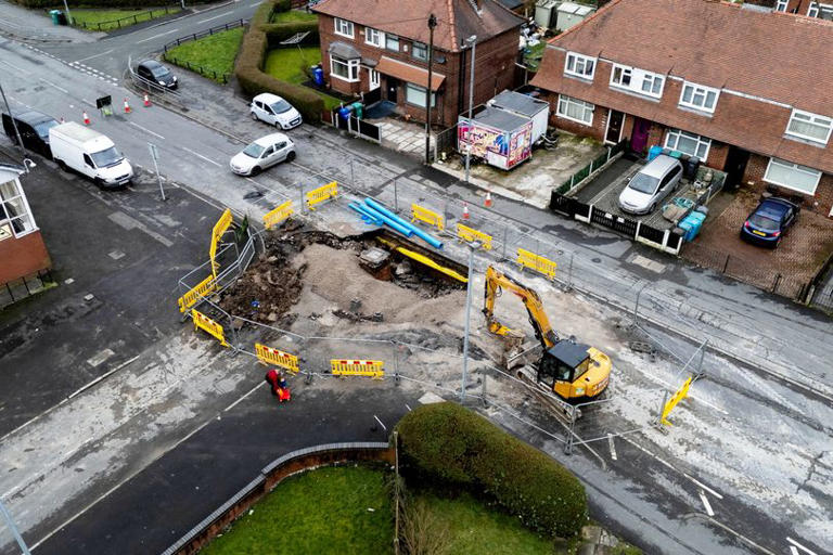 Massive 32ft sinkhole opens on Manchester street as images show its ...