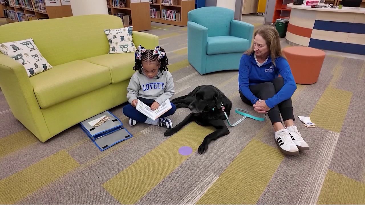 Students improve reading aloud skills with therapy dogs