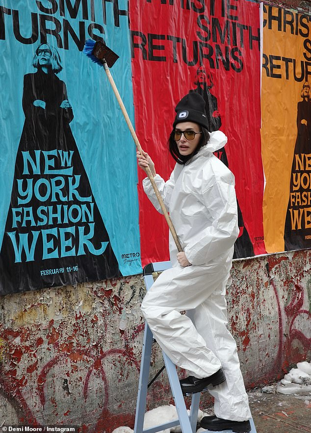 Demi Moore dons a hazmat suit to stick up posters for her new movie in NYC