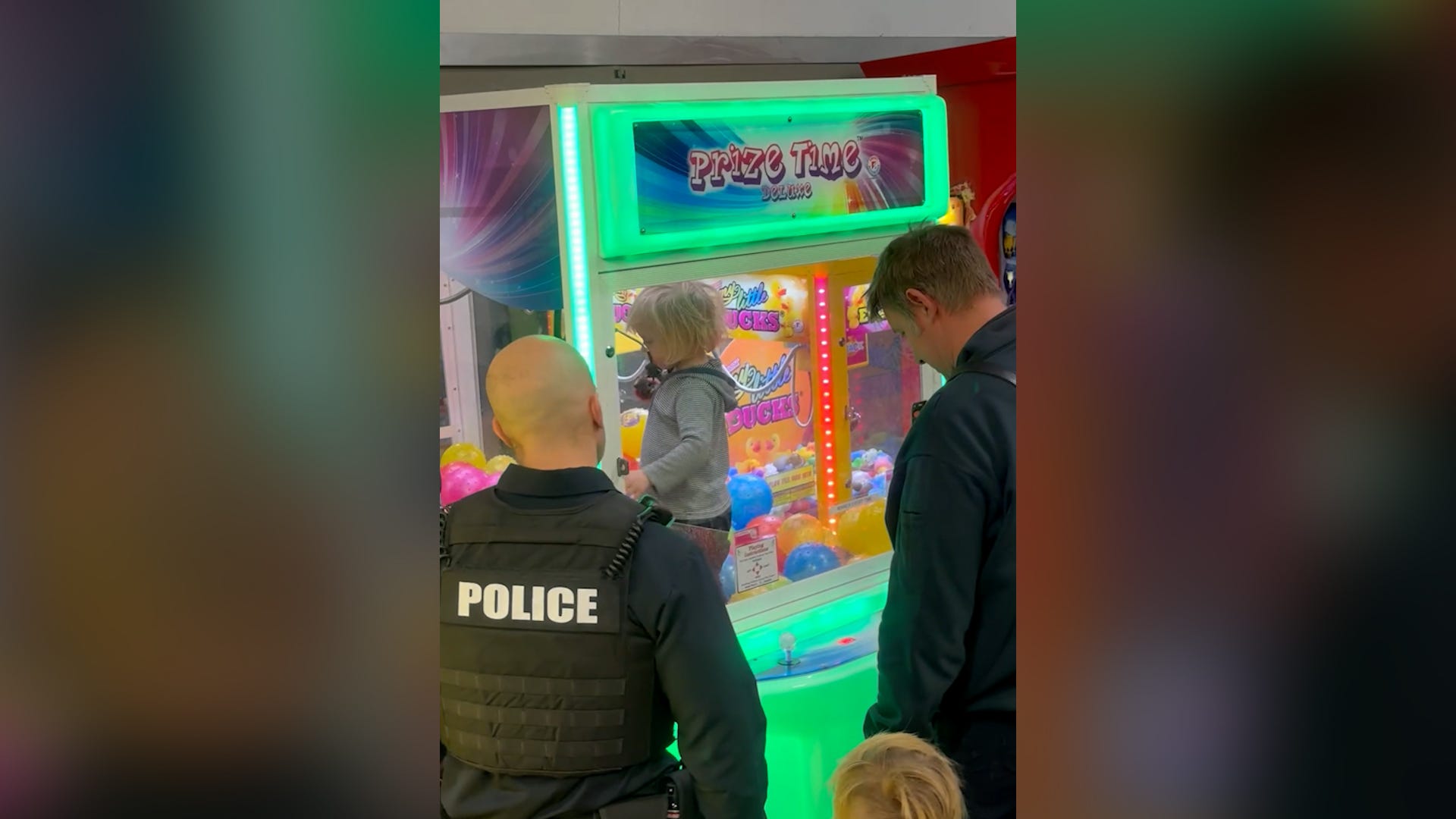 Watch toddler climb inside claw machine to play with toys