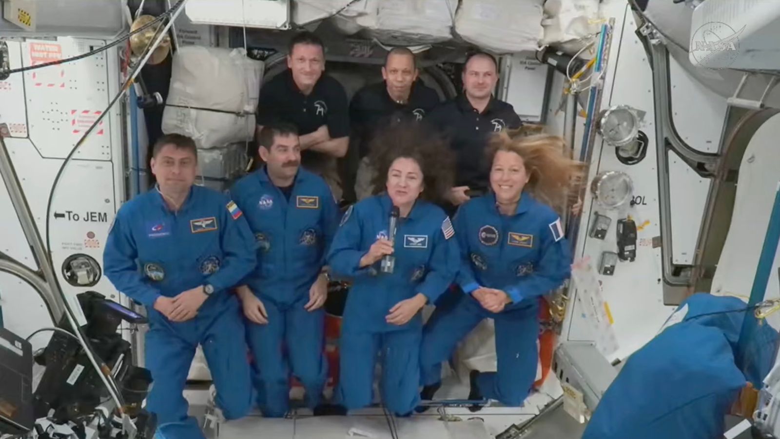 Astronauts hug and high-five as new crew arrive at International Space ...