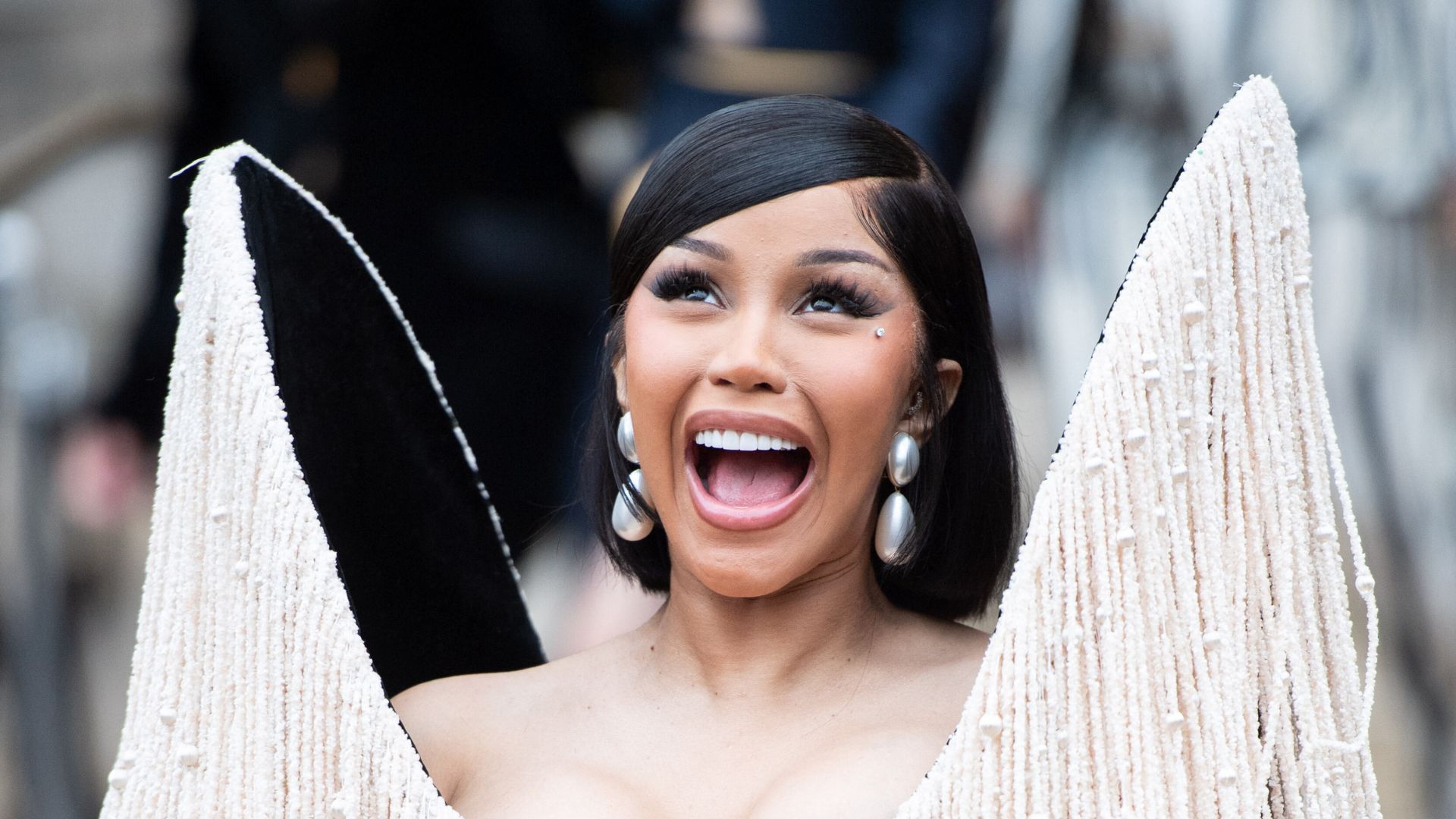 Cardi B accidentally falls off stage chair during concert performance