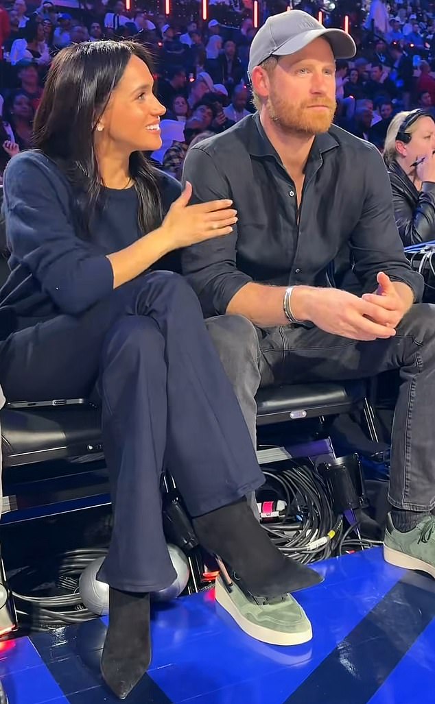 Meghan can't keep her hands off her Valentine Harry as she encourages ...