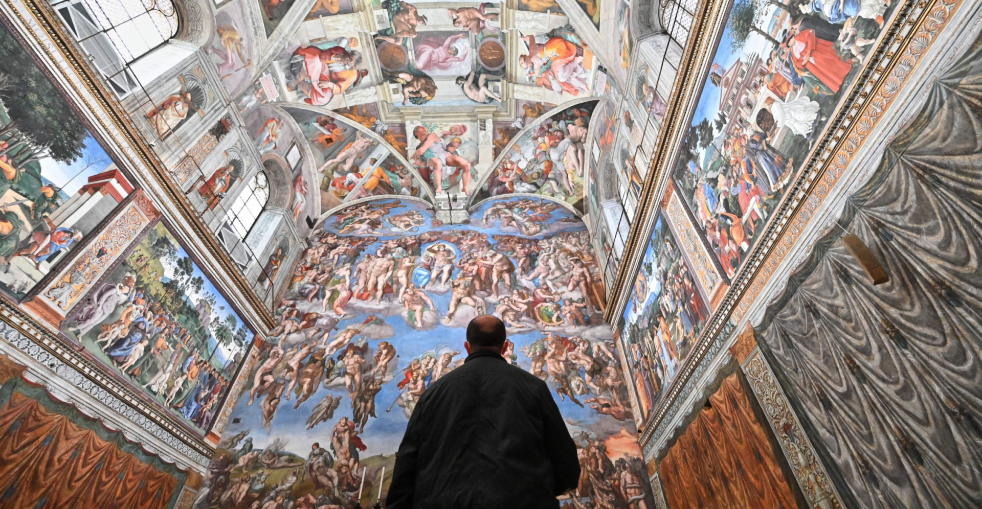 What is painted on the ceiling of the Sistine Chapel?