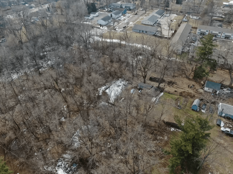 Police, excavator seen behind home in south Lansing