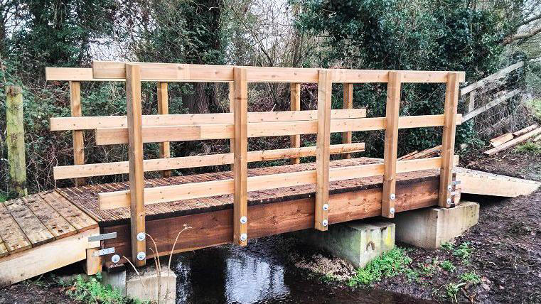 Volunteers build bridge at butterfly reserve