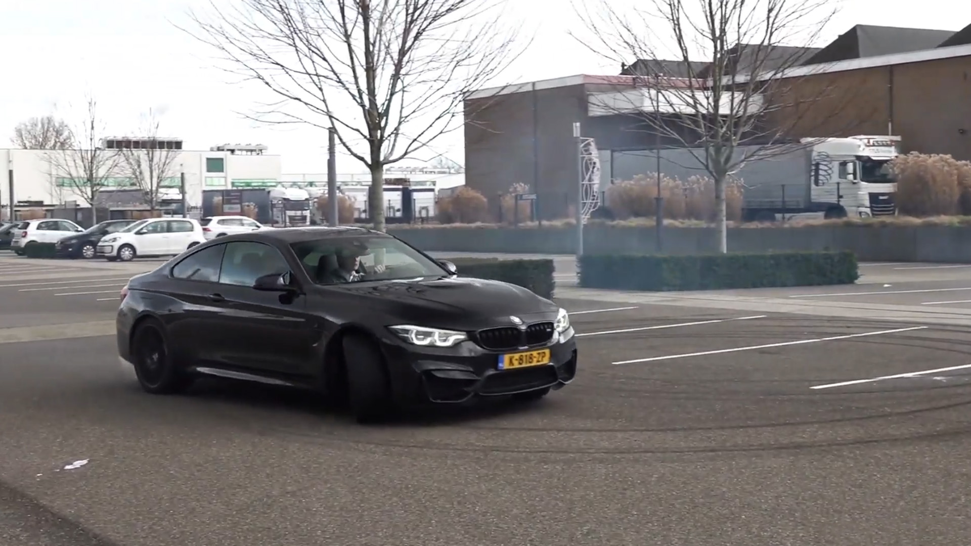 BMW M4 drift challenge in public parking area