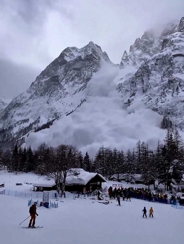 Moment avalanche cascades down mountain as skiers watch on before ...