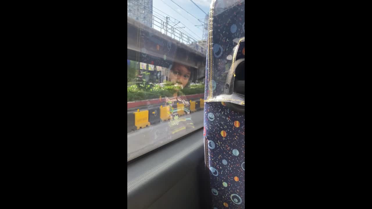 Toddler gives a chip to passenger behind him and receives donut in return