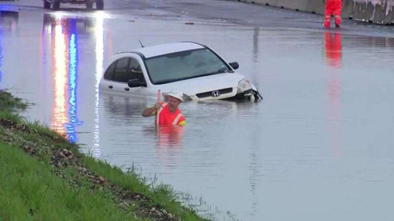 Video shows road crew braving chest-deep water in attempt to clear ...
