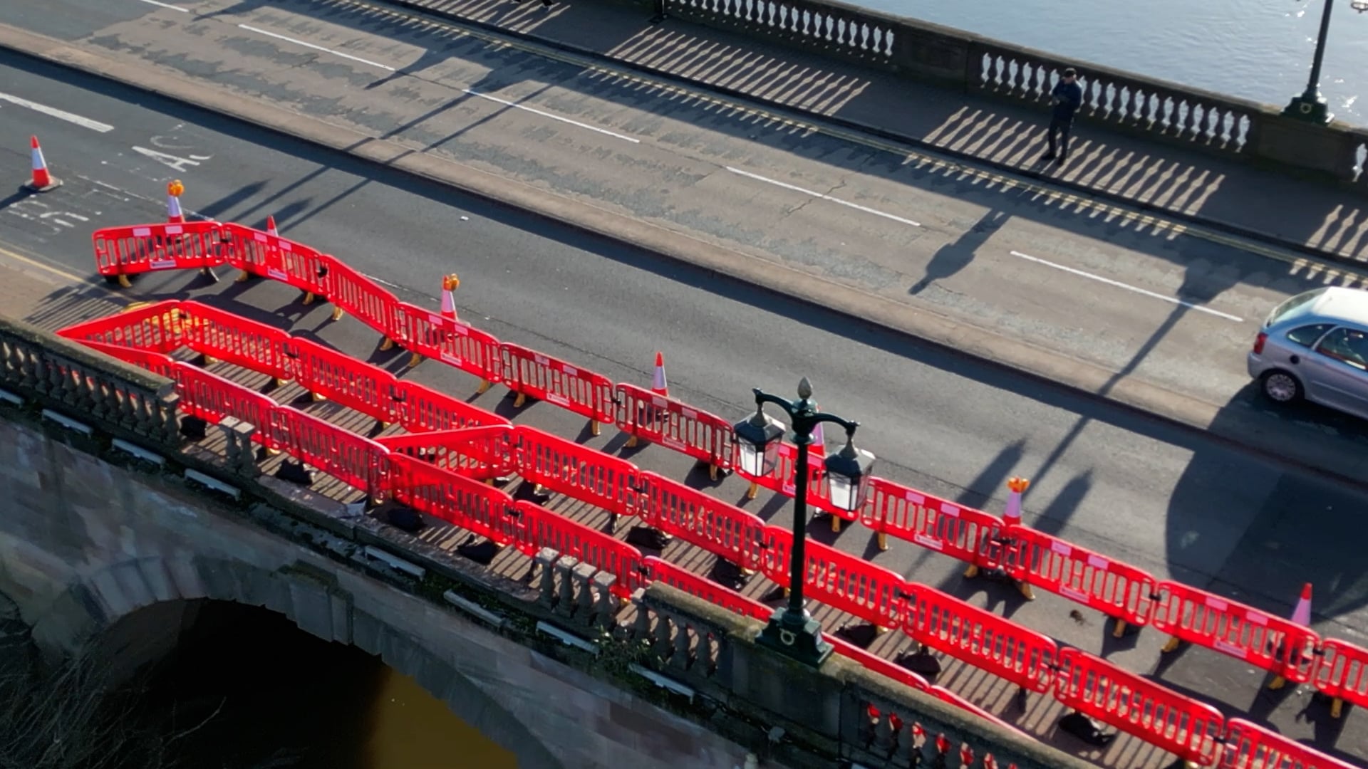 Damage after police car left dangling over edge of bridge during emergency
