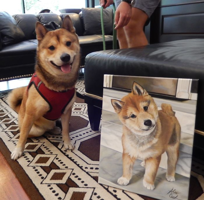 11 pets posing next to their hand-painted portraits