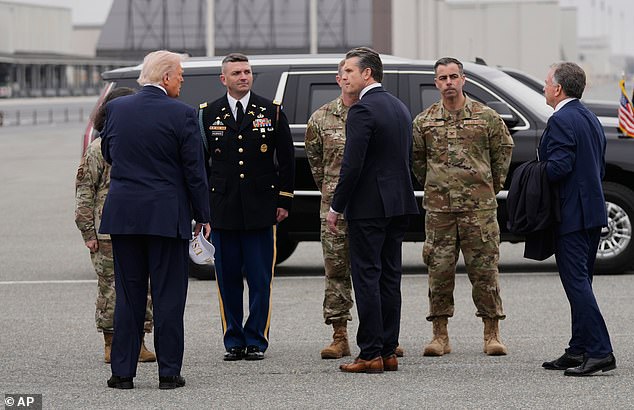 President Donald Trump salutes coffins of six fallen soldiers killed in ...
