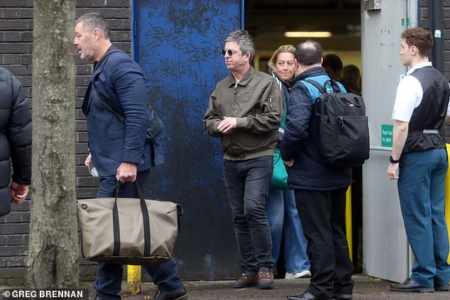 Noel Gallagher and Tori Cook sneak out of Euston Station side exit ...
