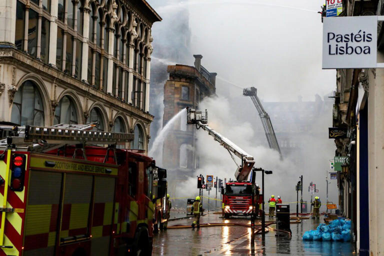 Firefighters still battling flames after vape shop explodes then collapses
