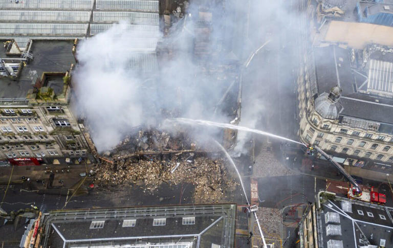 Firefighters still battling flames after vape shop explodes then collapses