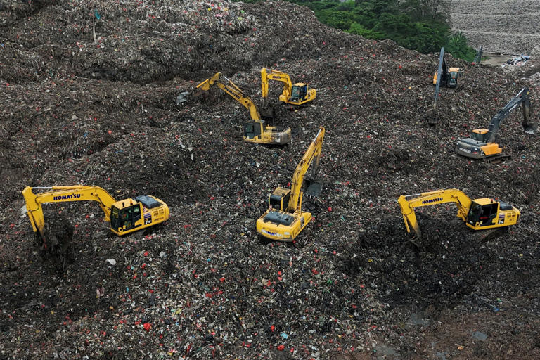 Five dead and more feared missing after giant landfill collapses