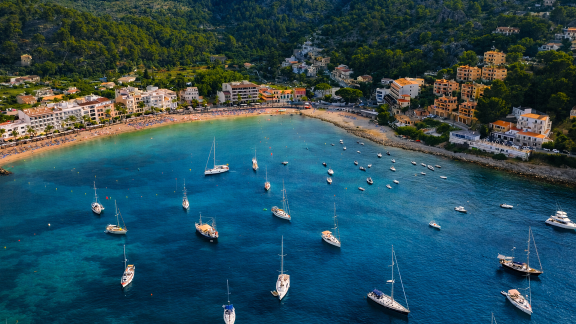 Where colorful boats rest in a perfect bay