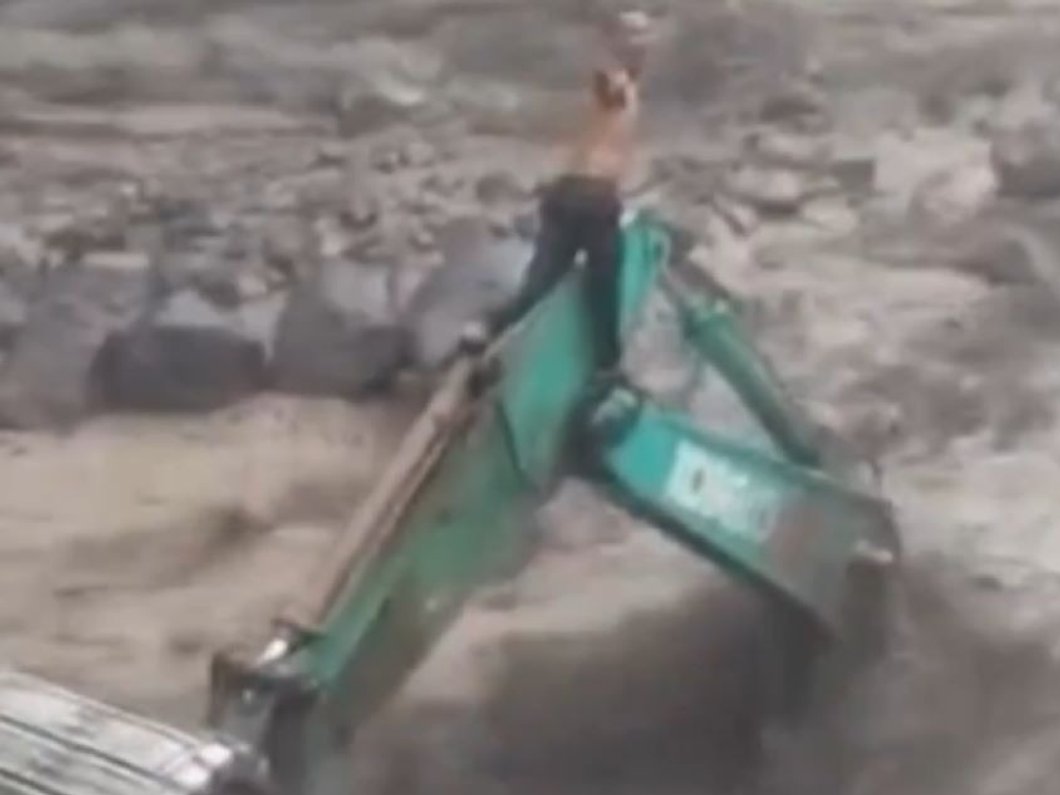 Trapped by floodwaters: Excavator operator fights for survival
