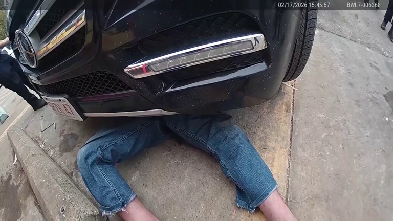 On camera: Police, fire rescue man pinned under car in parking lot