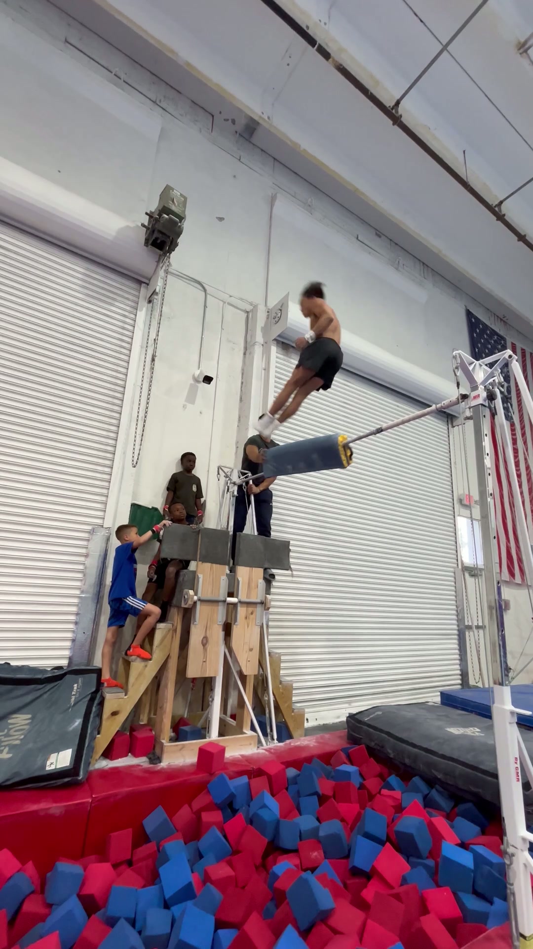 Young gymnast performing advanced high bar release move