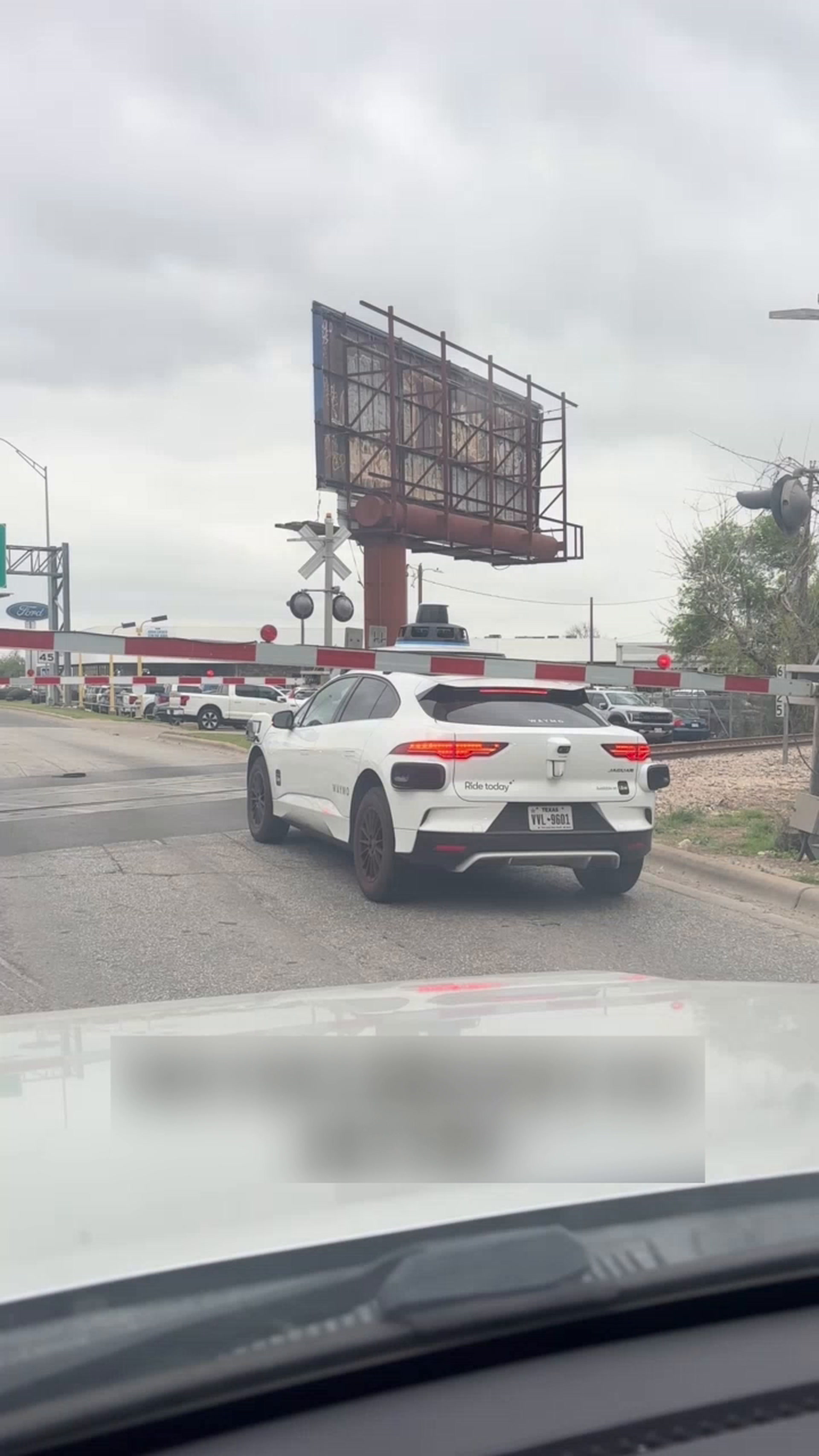 Terrifying Waymo stops between railway tracks and stop arm