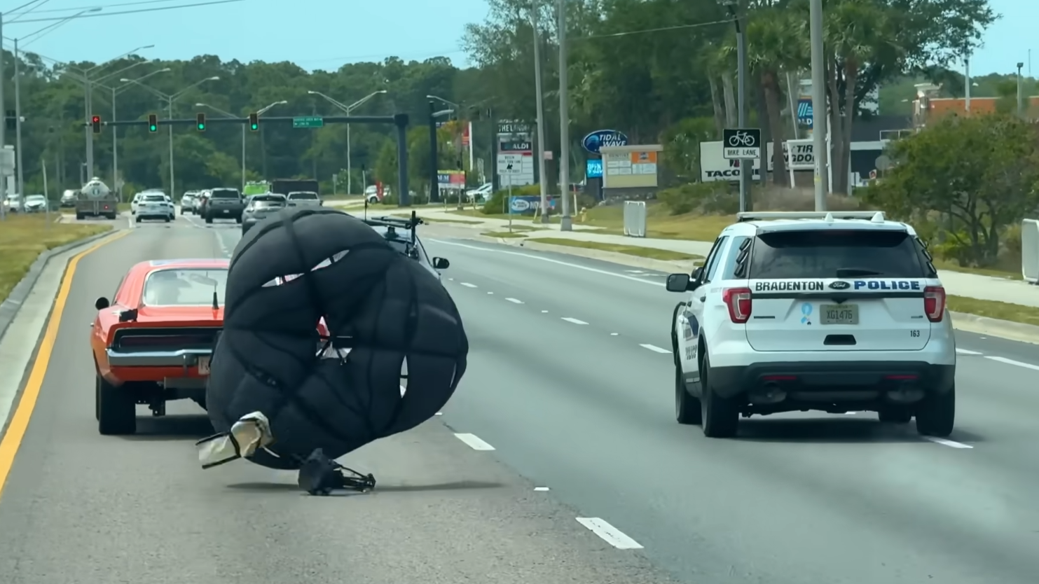 Watch what happens when a car deploys a parachute in front of cops