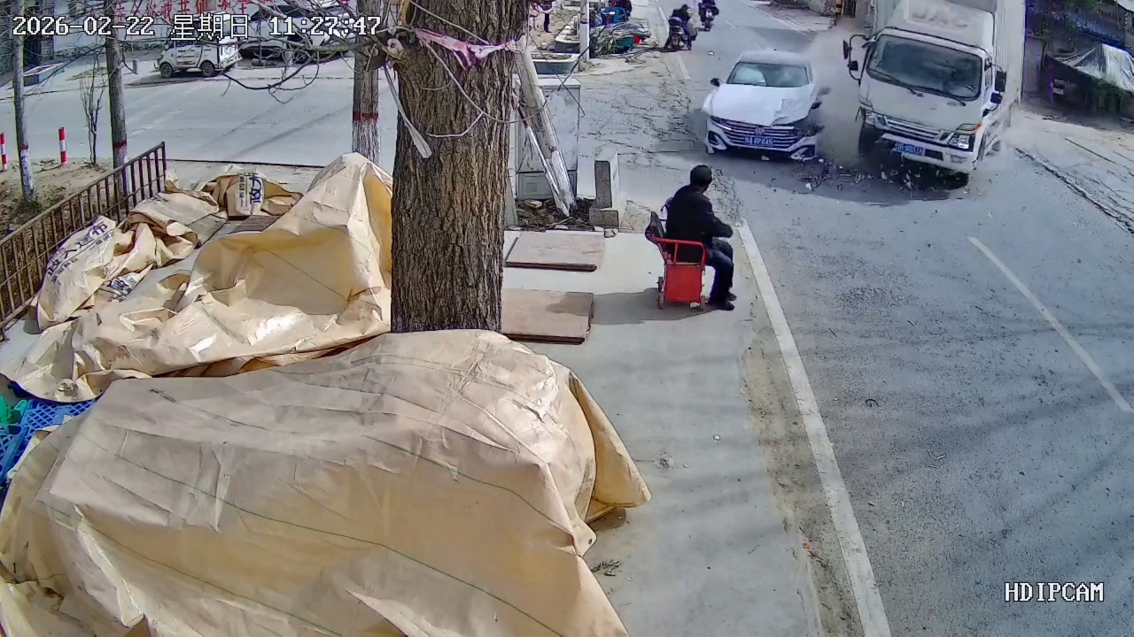 Intersection crash between car and truck caught on security camera in ...