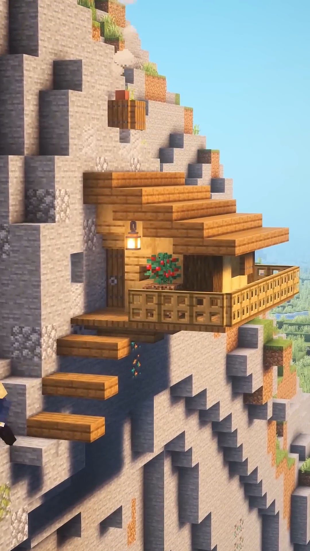 This hillside base blends into the Minecraft landscape