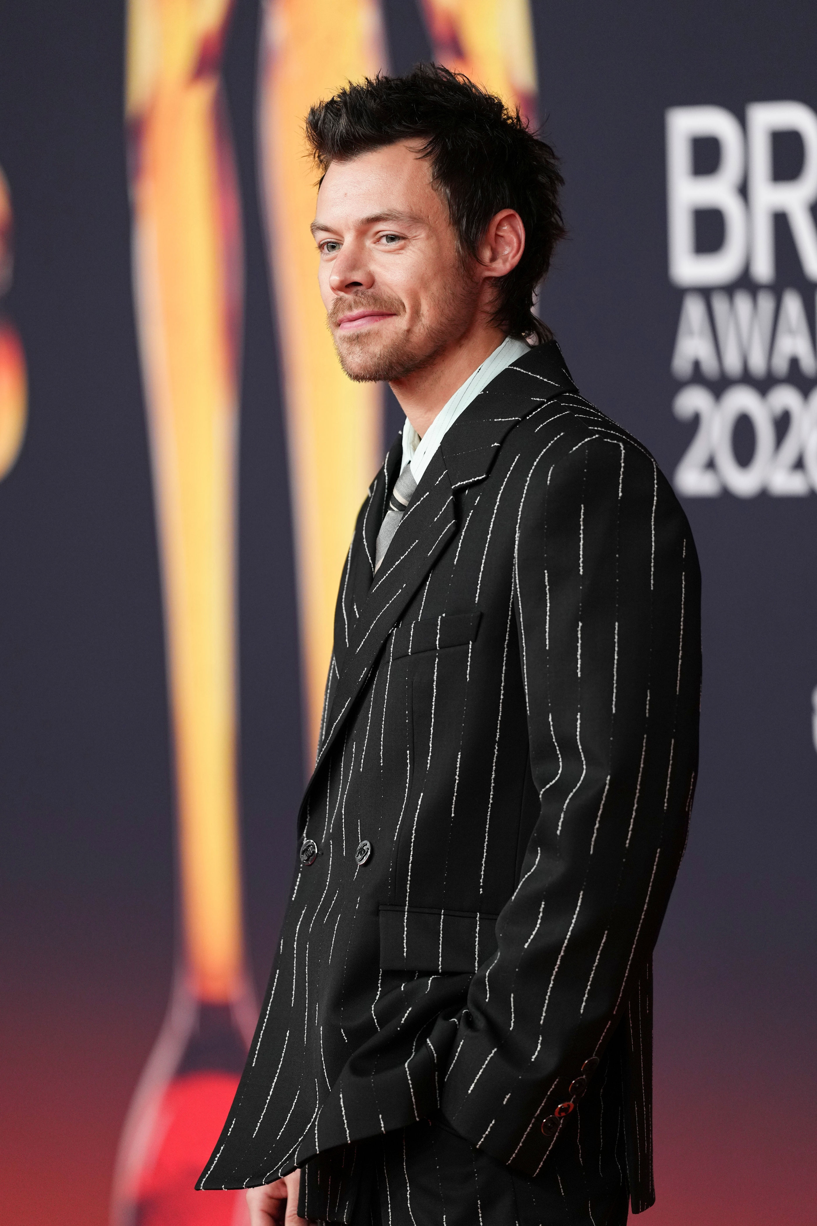 Harry Styles suits up in Chanel stripes and ballet flats at Brit Awards ...