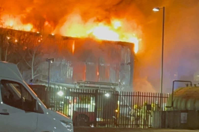 Huge fire breaks out in warehouse with 'thick black smoke spreading ...