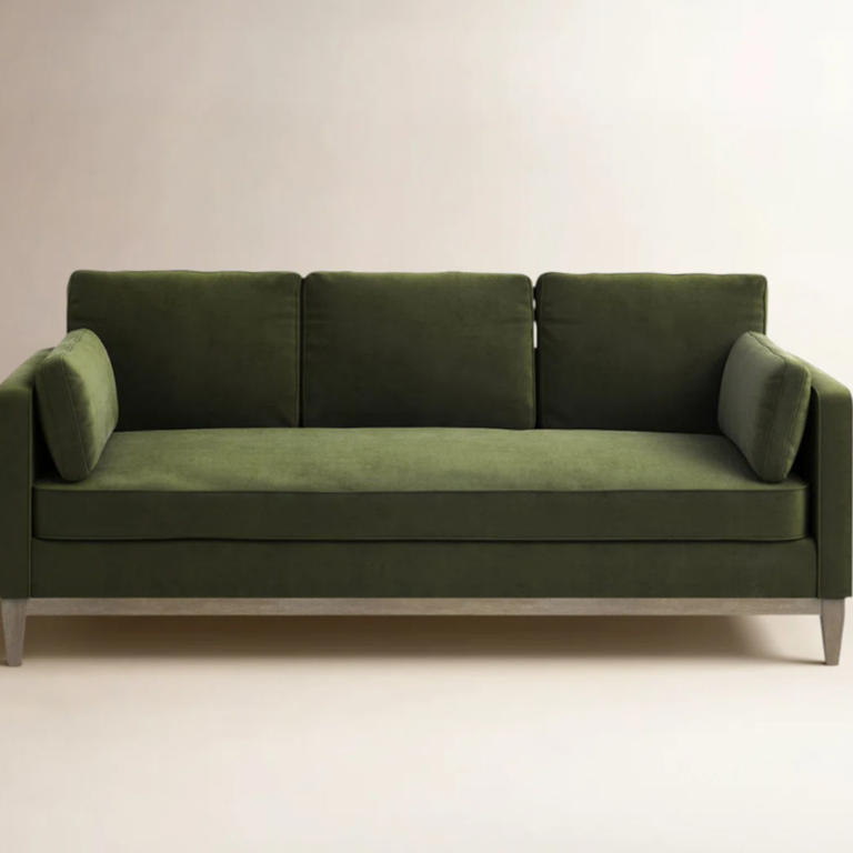 Zooey Deschanel reimagines antique-style decor with a dark green sofa ...