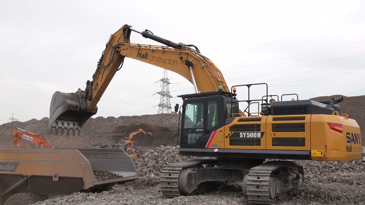 Huge excavator loading rock at quarry site
