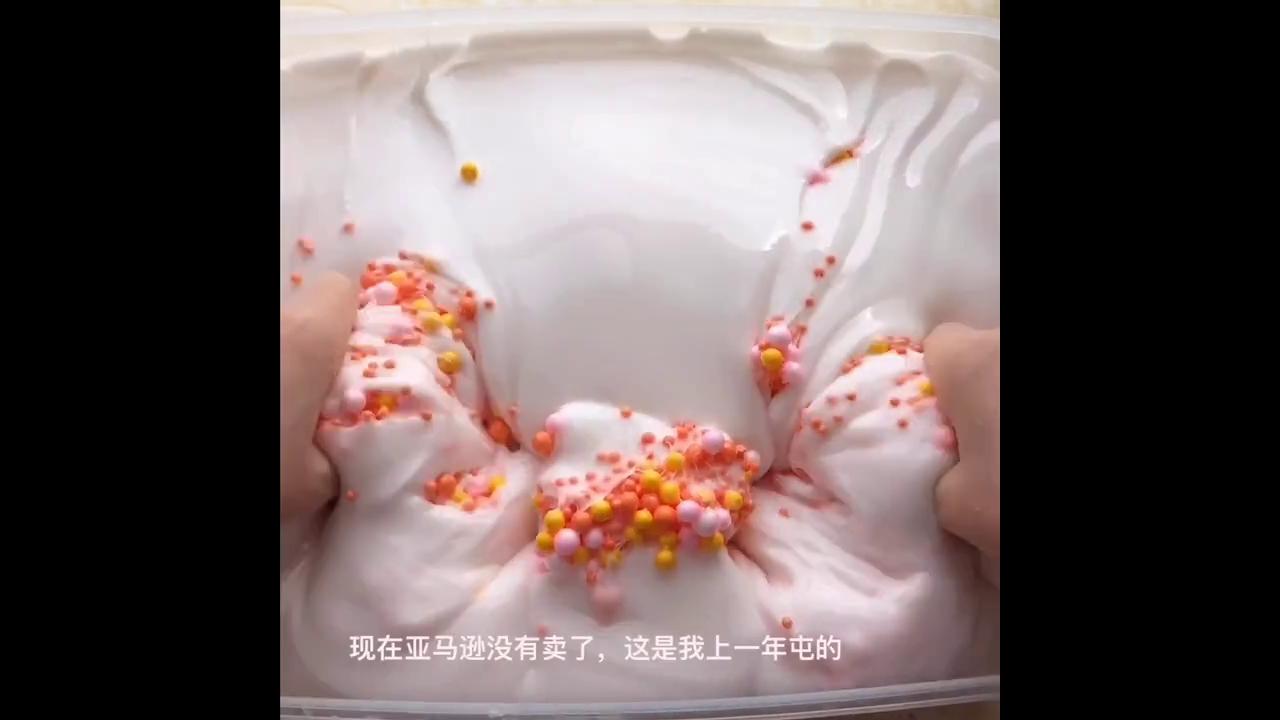 Crushing colorful foam balls on a watery slime