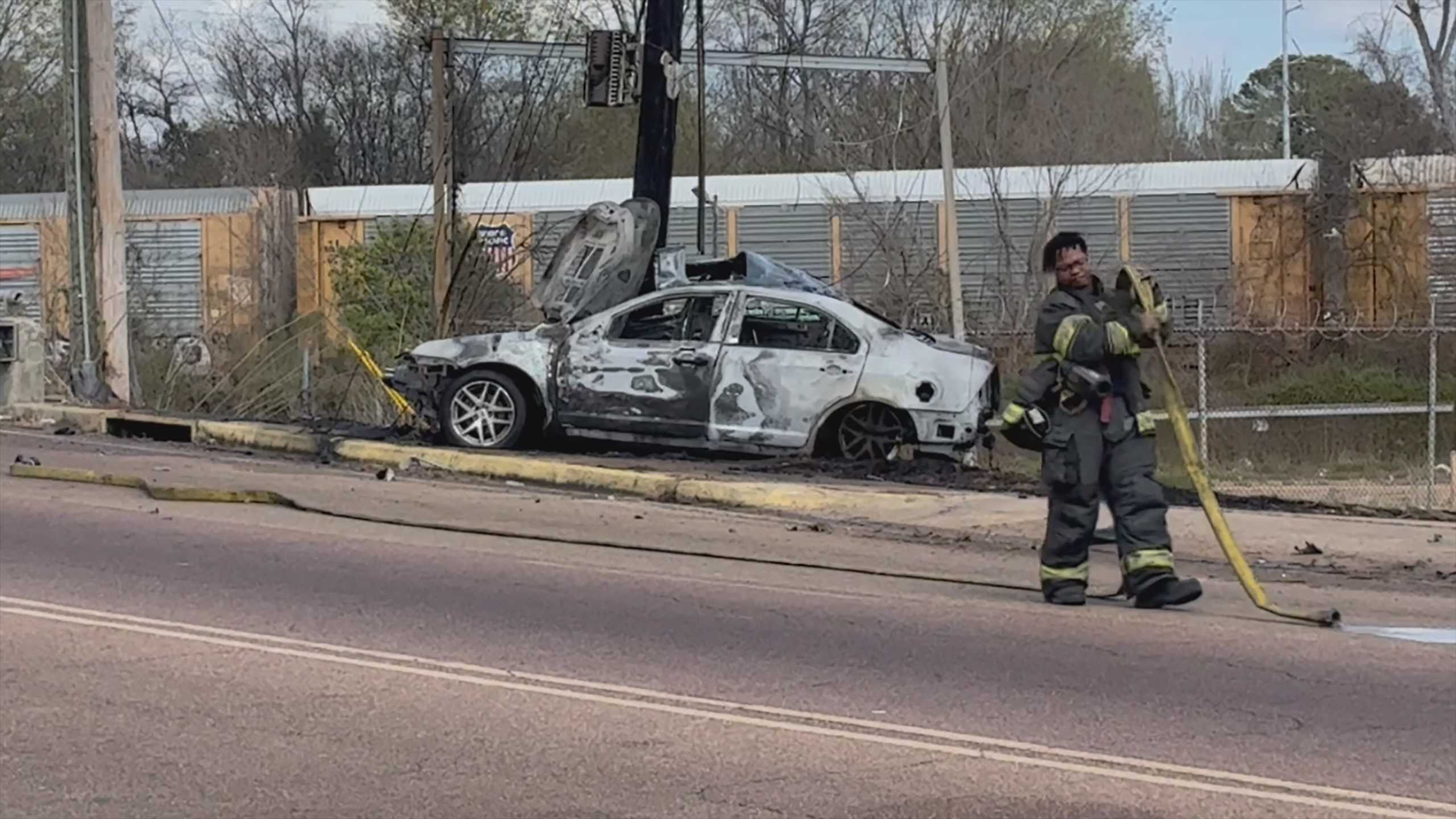Driver burned when car crashes into bridge and bursts into flames