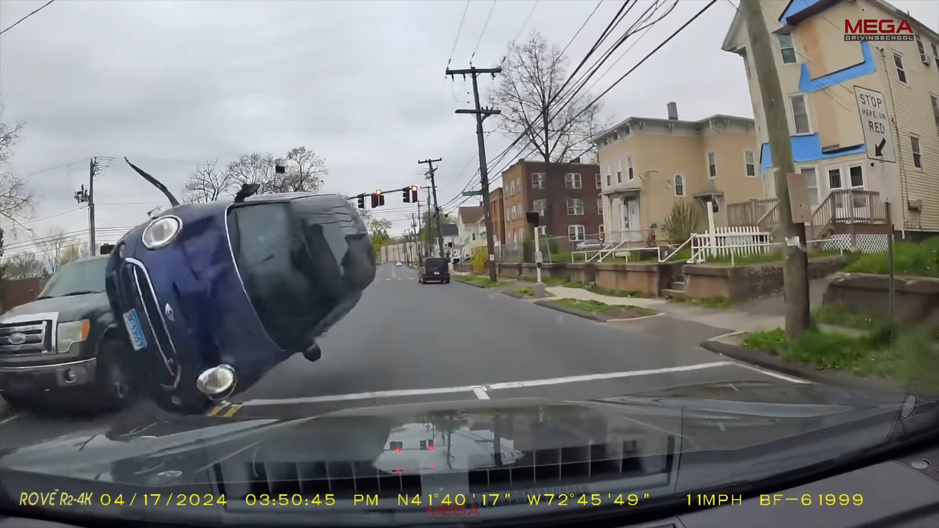 Red light runner slams into a truck and creates a horrible crash
