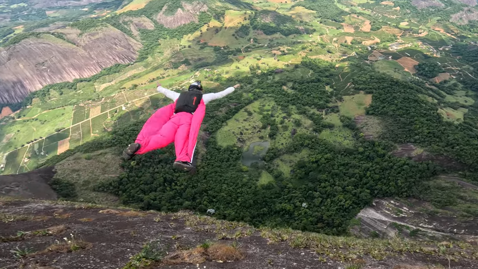Man jumps from a cliff into a dense Brazilian jungle