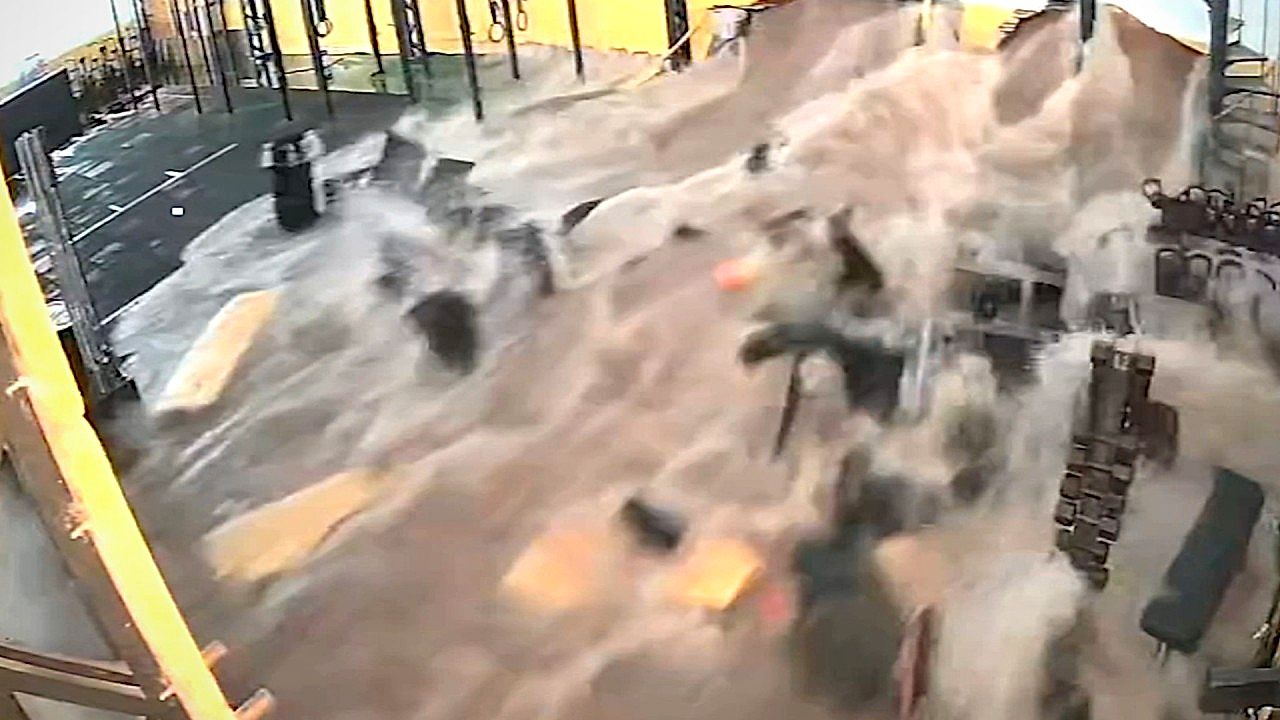A gym experiences moments of terror when a wall collapses due to flooding