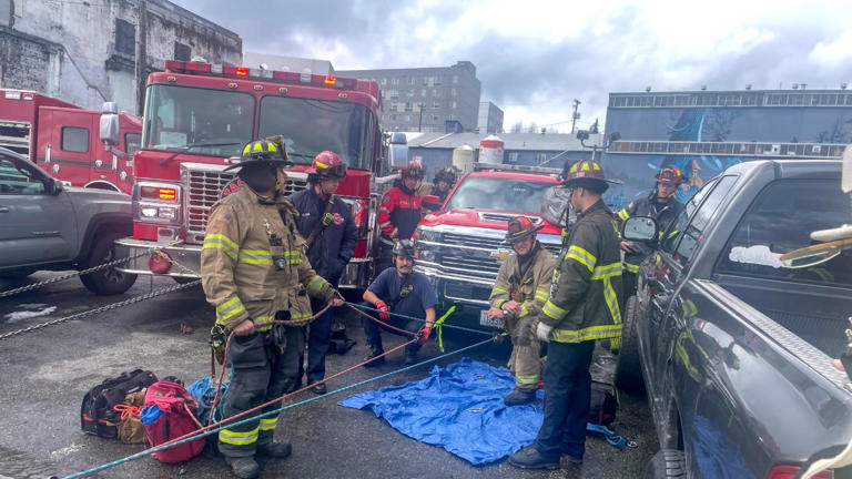 Driver rescued from car dangling over 20 foot drop in Tacoma, WA