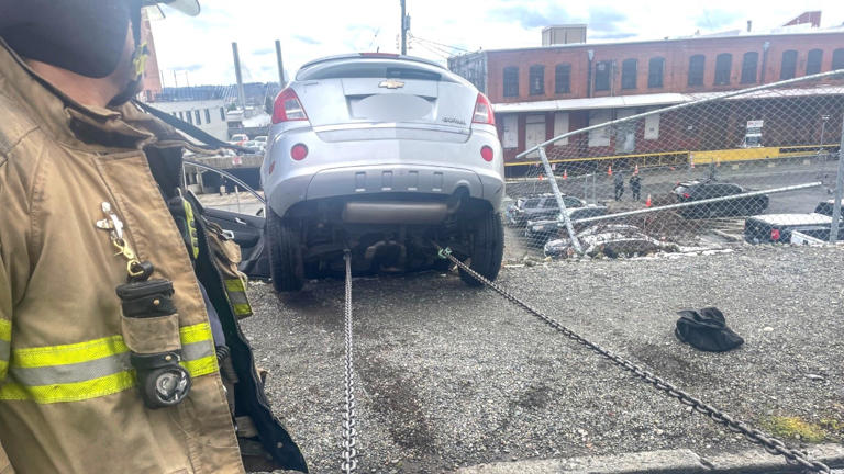 Driver rescued from car dangling over 20 foot drop in Tacoma, WA