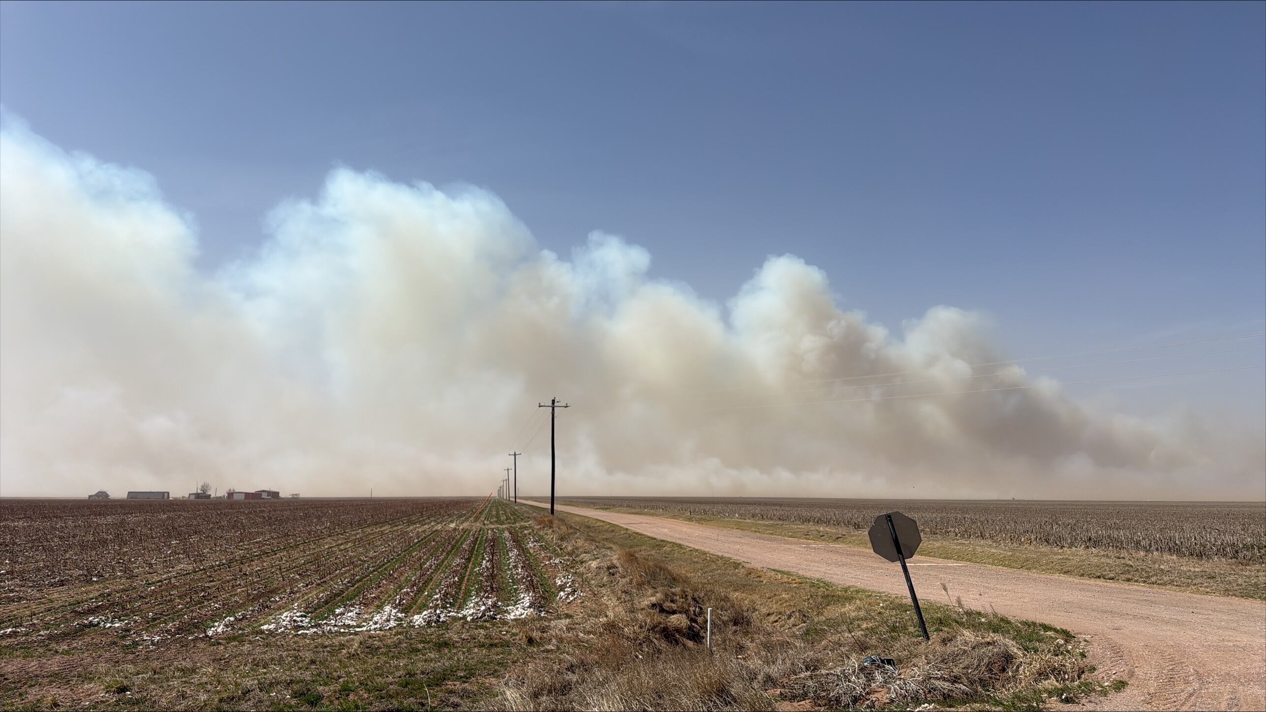 Grass fire burns in Jackson County river bed, strong winds hampering crews