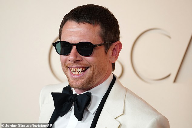 Sinners star Jack O'Connell arrives on the Oscars red carpet with blood ...