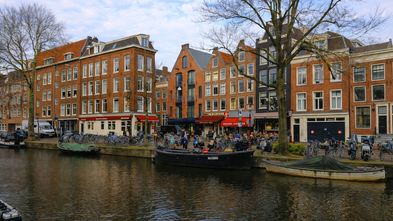 Walking along a quiet Amsterdam canal