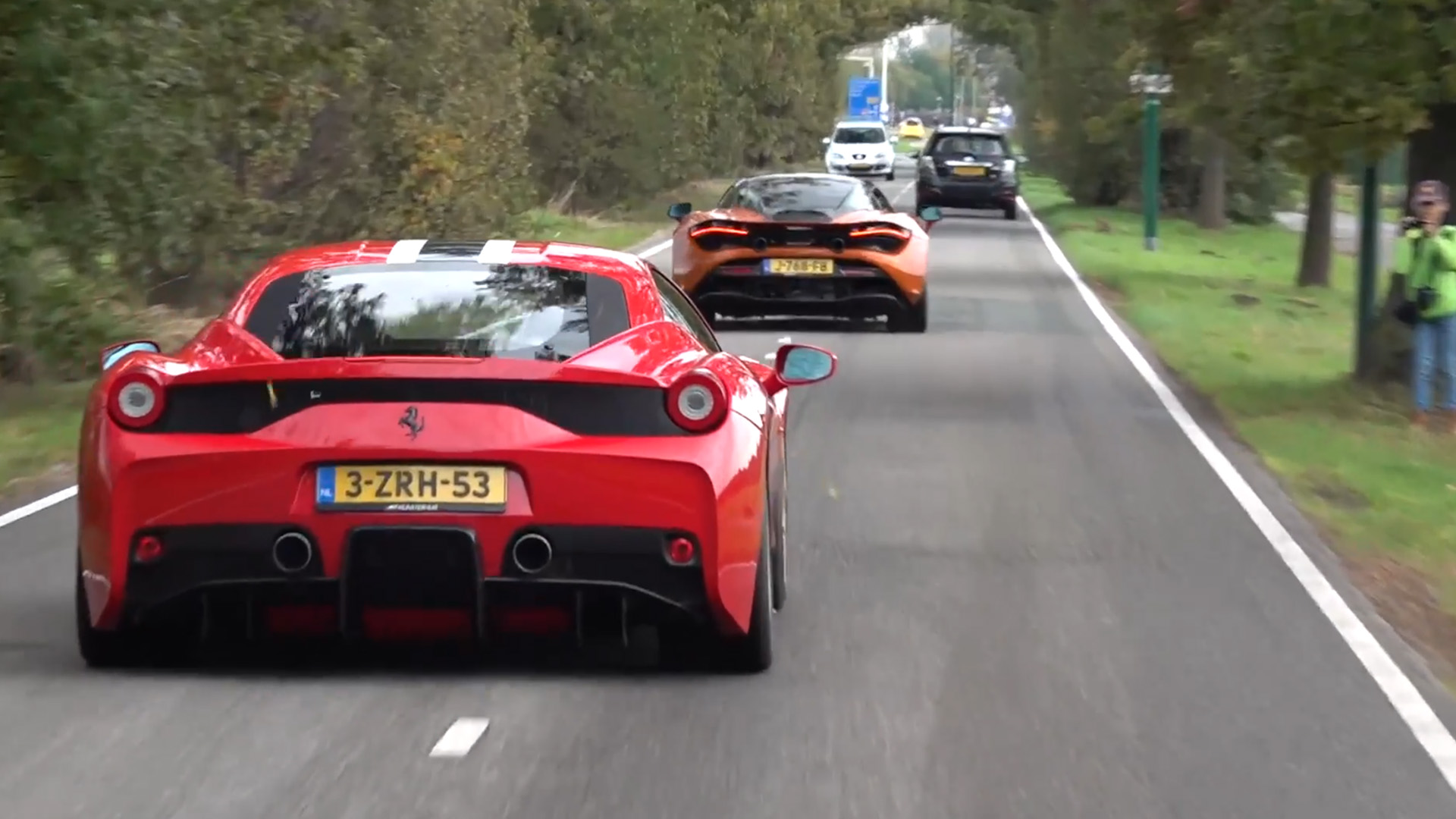 Ferrari 458 Speciale chasing a McLaren on open road